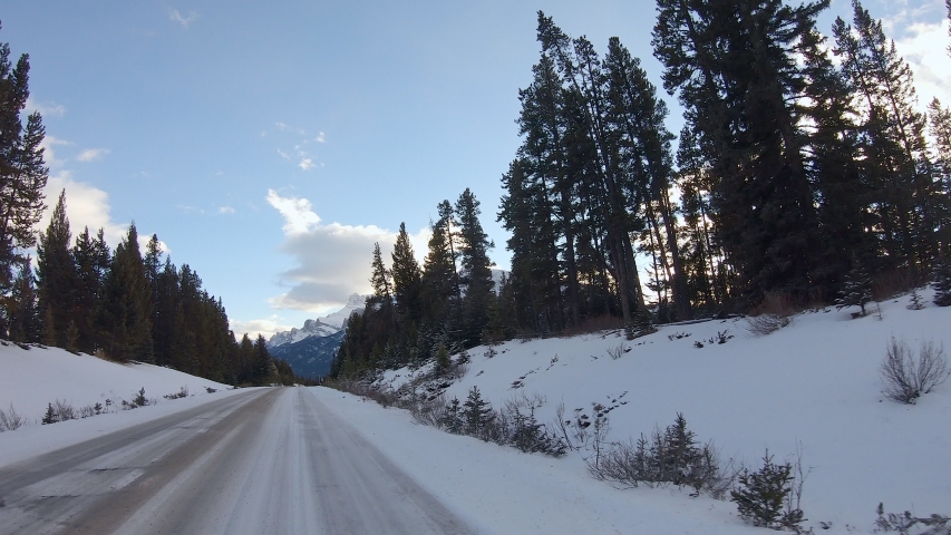 Driving on the road into the mountains in Banff National Park, Alberta ...
