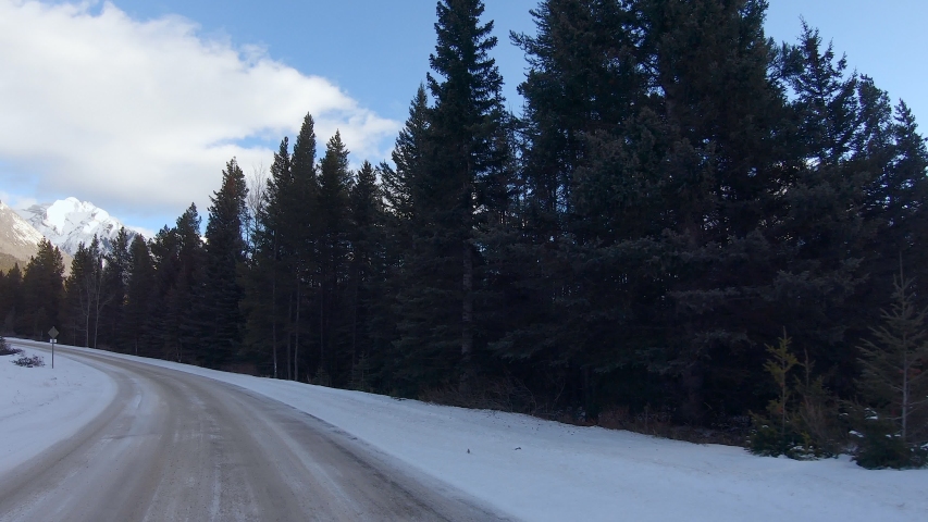 Driving on the road into the mountains in Banff National Park, Alberta ...