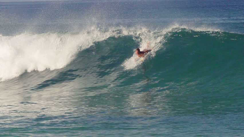 Surfer On Big Blue Ocean Wave Wipes Out In The Barrel. Big Shorebreak ...