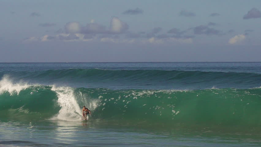 Surfer On Big Blue Ocean Wave Wipes Out In The Barrel. Big Shorebreak ...
