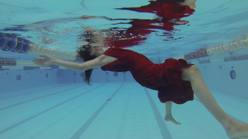 SLOW MOTION: Woman Wearing Red Dress Having Fun Inside Swimming Pool ...