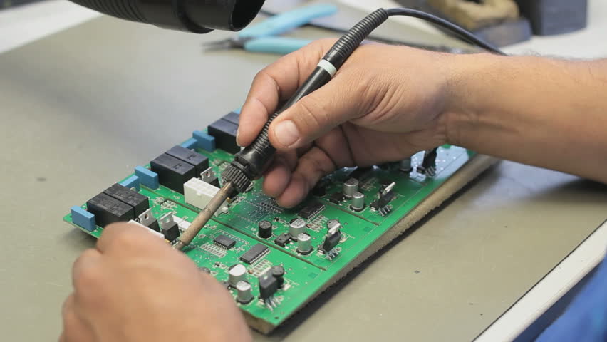Electronic Technician Fixes Circuit Board Cables At The Repair Service ...
