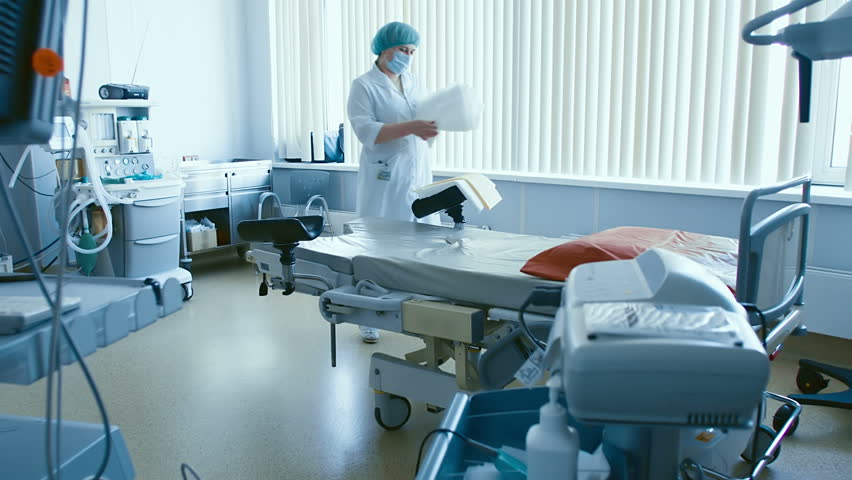 A Doctor Is Preparing A Pregnant Woman Lying In The Medical Bed In The ...