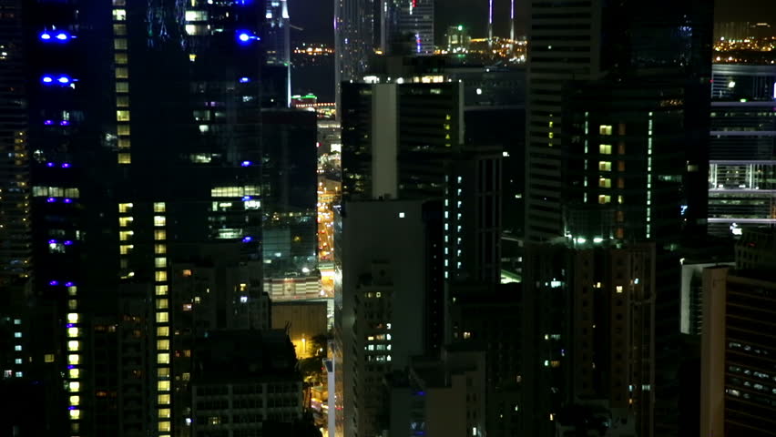 Descending Night View From The Top Of High Rise City Buildings To Lower ...