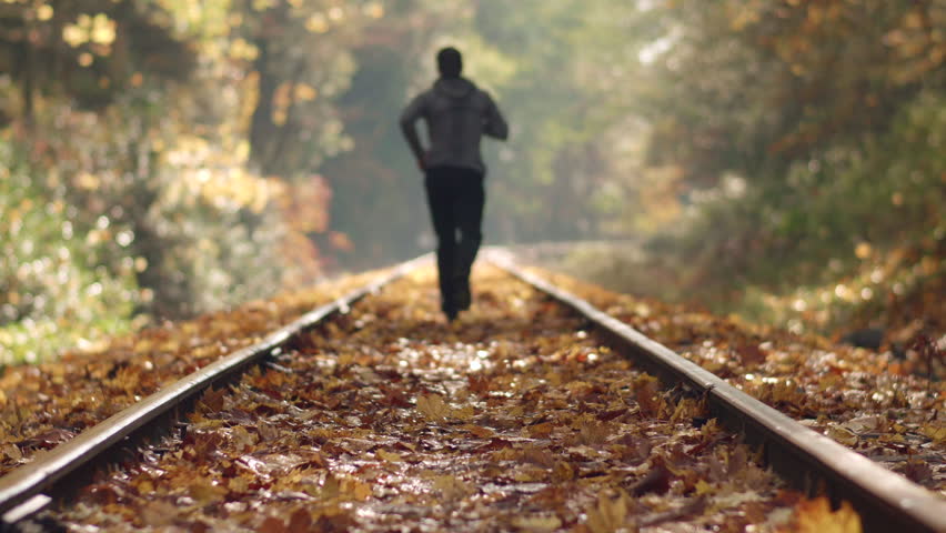 Stock video of man jogging down train tracks in | 12763826 | Shutterstock
