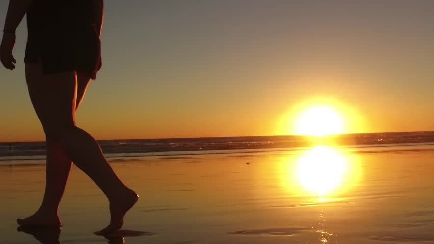 Medium Shot Tracking Girl Walking On Beach At Sunset With Beautiful ...