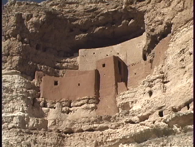 Stock Video Clip of Ancient cliff dwellings overlook a forest in ...