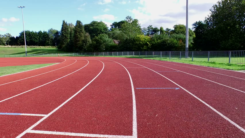 4K Drone Footage Of Track Athletes Crossing Finish Line At Running ...