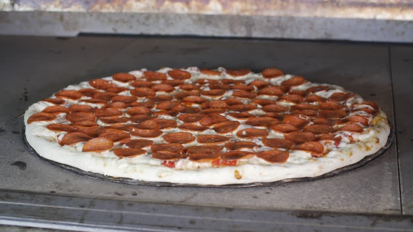 Slow Motion Close-up Of Drooping Slice Of Pepperoni Pizza Cooked In ...