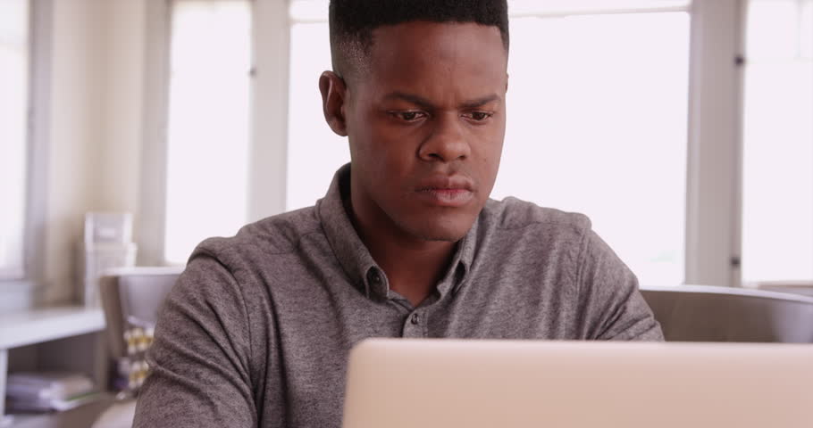 Attractive Young Man Sitting In Front Of The Computer Screen And ...
