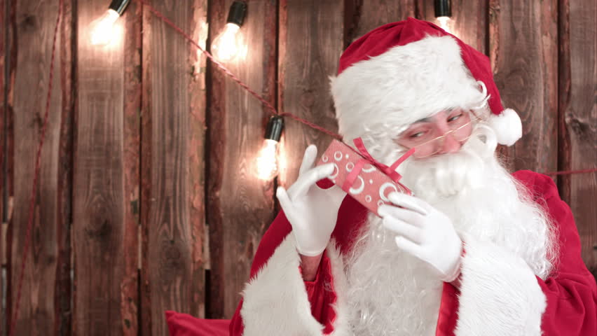 A Fake Santa Claus Shows His Gifts Under The Tree. Vintage Textures ...