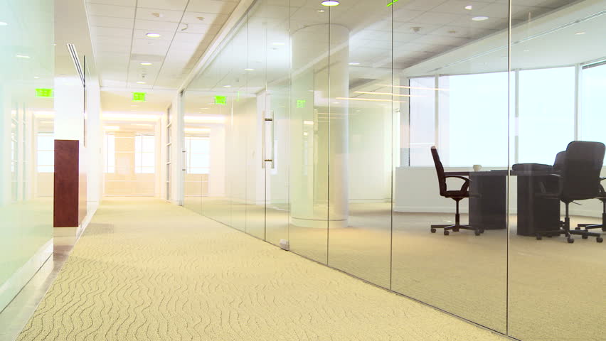 Group Of Business Professionals Walking Away Down Office Hallway Stock ...