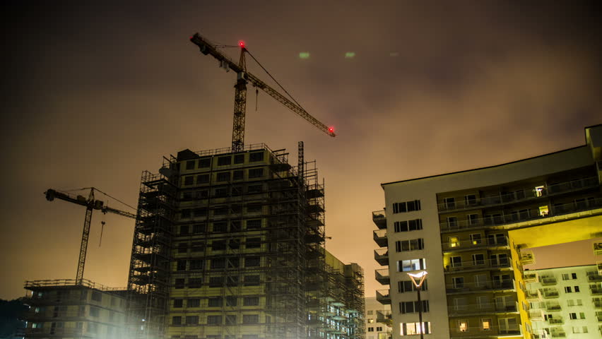Construction Site At Night Time Lapse. Working Tower Cranes, Buildings ...