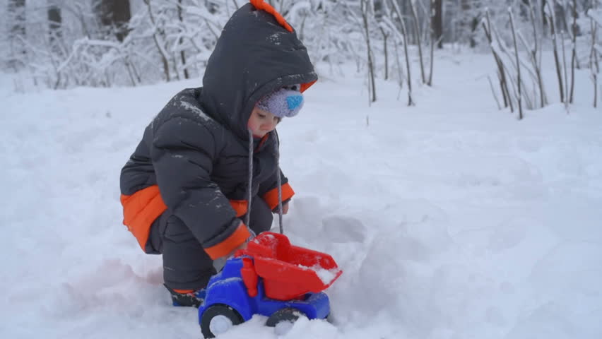 Children's Winter Games Outdoors. The Image Of A Child Plays With Snow ...