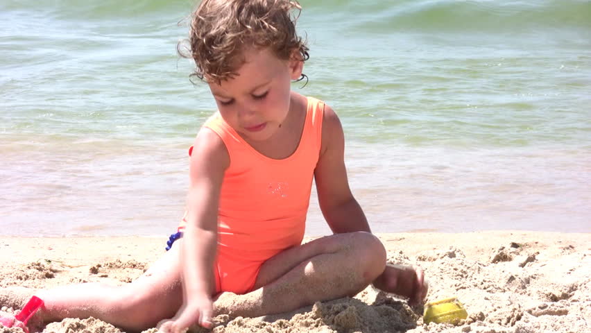 Little Girl Playing In Sand On Beach, Child Bathing In Sea Water Waves ...