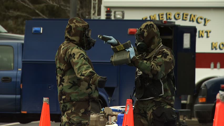 HAZMAT Team Members Wearing Protective Suits To Protect Them From ...