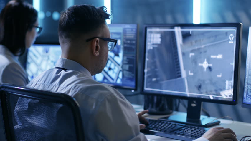 Group Of People In Mission Control Center Filled With Displays ...