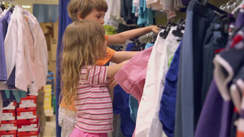 Excited Shopping Girl Rummaging Through Clothes In The Sales Section ...