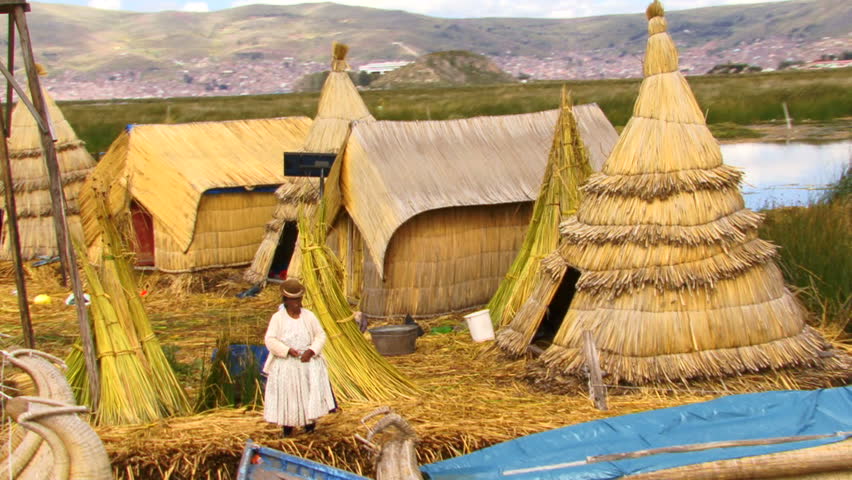 PUNO, PERU - April 2009: Reed Houses In A Small Village Of Native ...