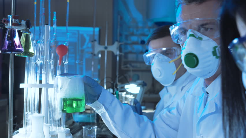 Stock Video Clip of Group of chemists working in a laboratory ...