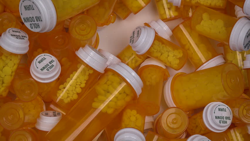 Consumer Sorts Through Dozens Of Prescription Medication Bottles ...