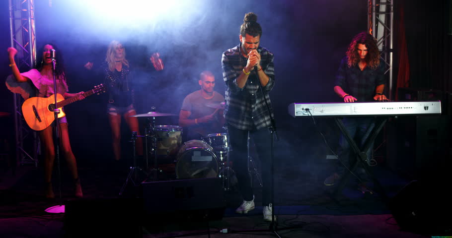 Concert Rock Band Performing On Stage With Singer Performer, Guitar ...