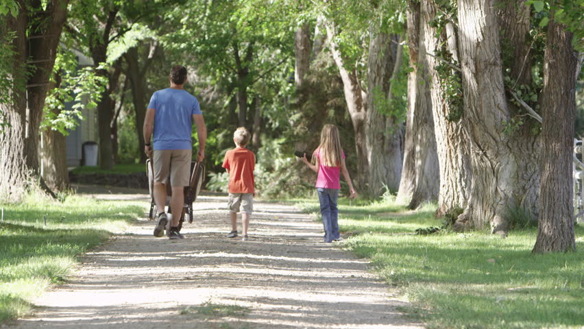 3 Happy Friends Walk Down Path Through Park Toward Camera Stock Footage ...