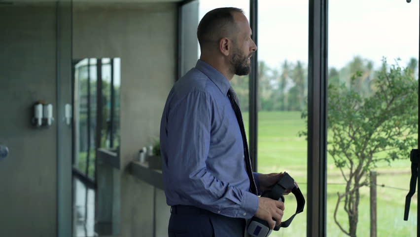 Man Looking Out Window Watching Heavy Wind And Rain During Storm. Stock ...