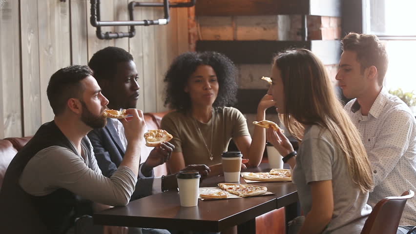 Business Team Of Young People Enjoying Eating Pizza Together