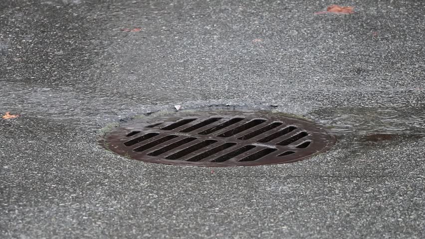 Manhole Rainy Day. Water From Heavy Rain Flows Through A Manhole Cover ...