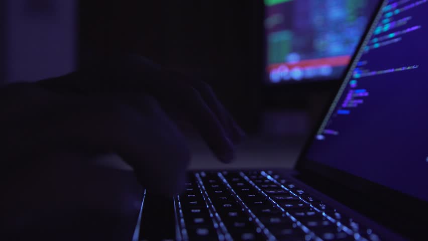 Stock Video Clip of Male hacker working on a computer in | Shutterstock