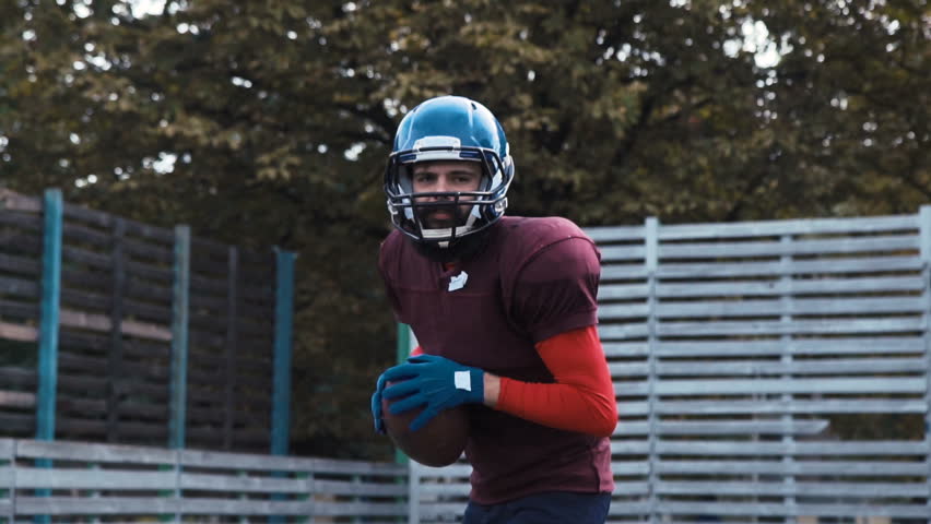 Slow Motion Of American Football Player Practising Throwing Ball During ...