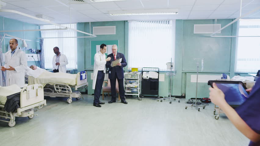 Hospital Staff Are Doing Their Rounds And A Young Medical Assistant ...