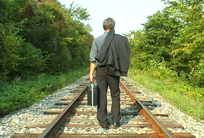 Video Of A Business Man Walking On A Railroad Track At The Middle Of ...