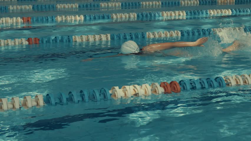 Swimmer In Action In Waterpool With Blue Water At Sunny Day. Slow ...