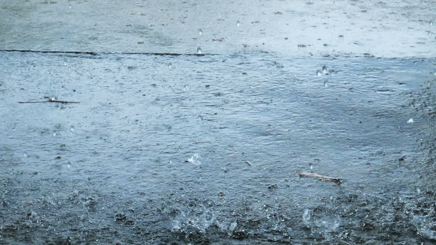 Stock Video Clip of Closeup shot of heavy rain on road | Shutterstock