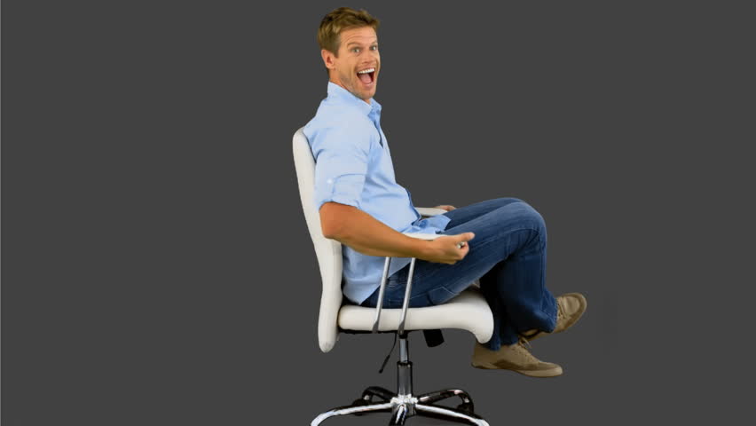Smiling Man Turning On Swivel Chair On White Background In Slow Motion ...