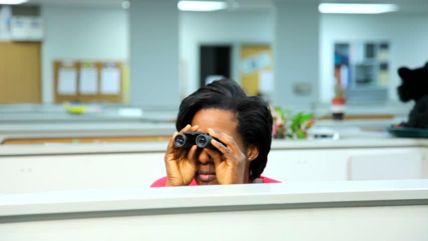 Stock video of businesswoman peeks over cubicle with binoculars ...