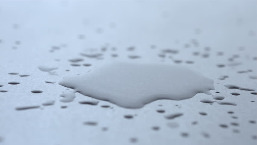 Stock Video Clip of Water drip splashing on wet surface, slow ...