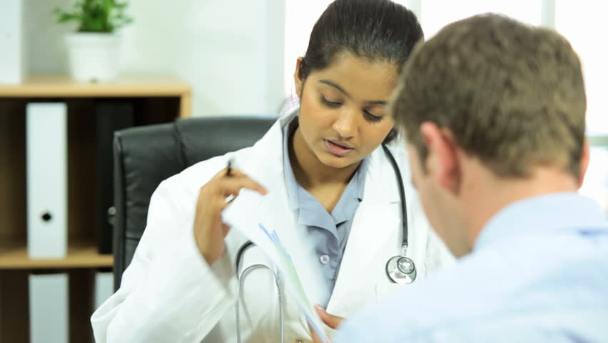 Young Indian Doctor Discussing Surgery Results And Treatment Options ...