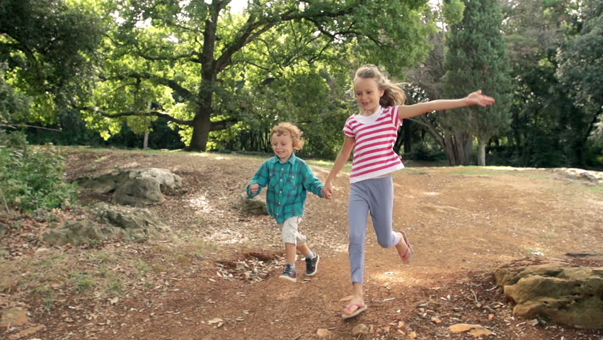 Slow Motion Shot Of A Little Brother And Sister Running Towards Each ...