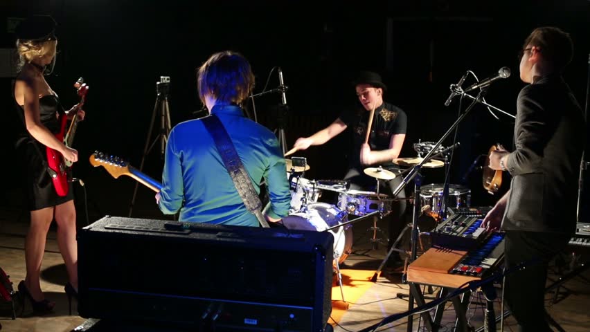 Rock Band Of Four Members Work In Studio With Smoke. Vocalist Man Sings ...