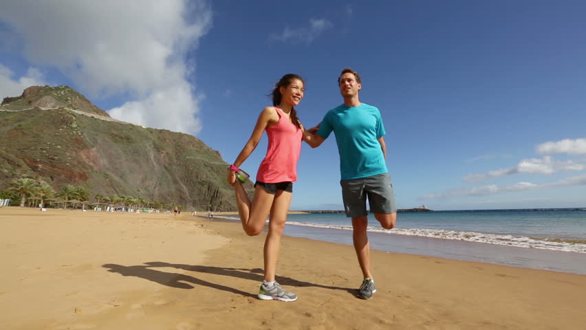 Exercising Running Couple Jogging On Beach. Runners Training On Sand By ...