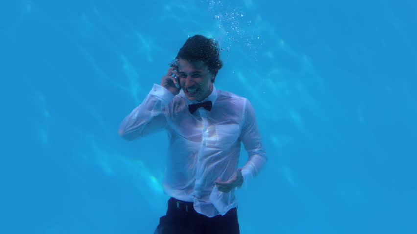 cheering businessman underwater in pool talking | 6557396 的库存视频 ...