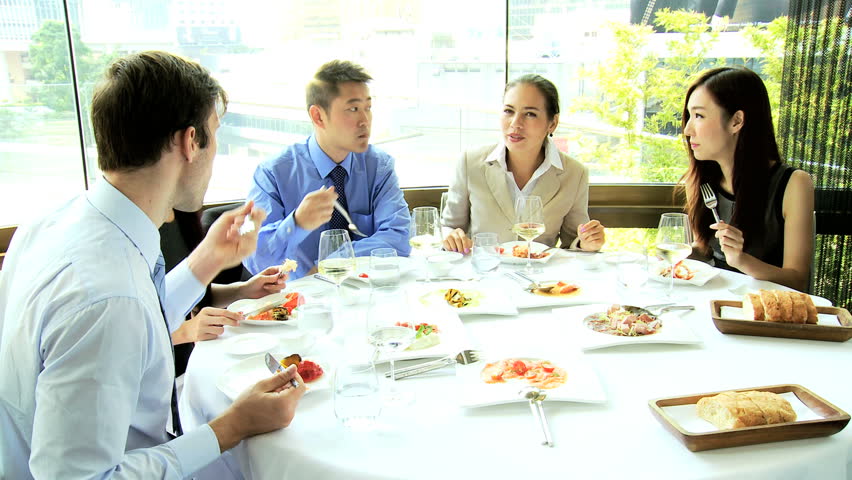 Camera Moves Around Table As Group Of Friends Sit In Cafe Eating And ...
