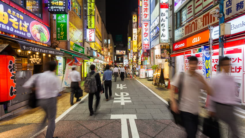 TOKYO, JAPAN - MAY 23: People And Vehicles Cross The Famous Shibuya ...