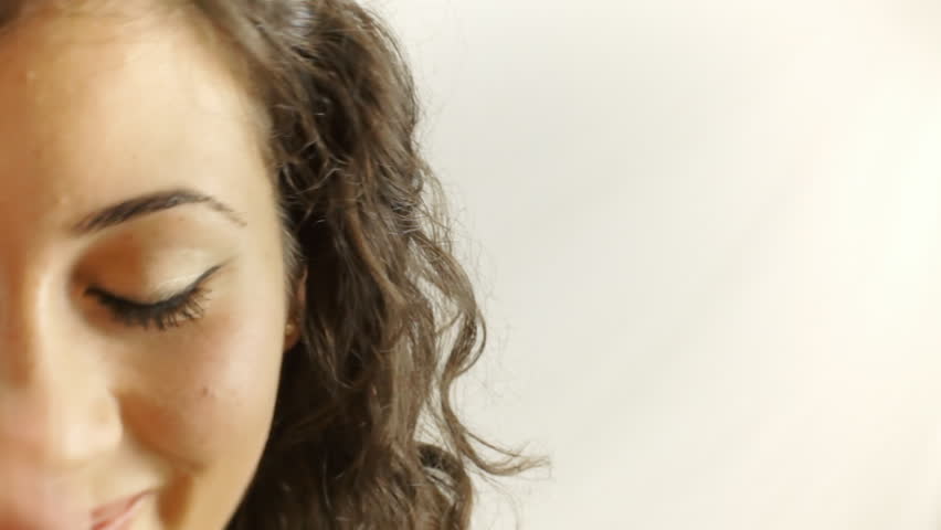 A Young And Beautiful Woman Smiles In A Seductive Manner. She Then ...