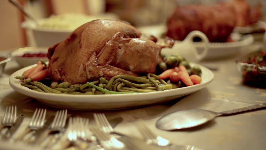 Thanksgiving Table With Turkey And Side Dishes And Man Carving, Slicing ...