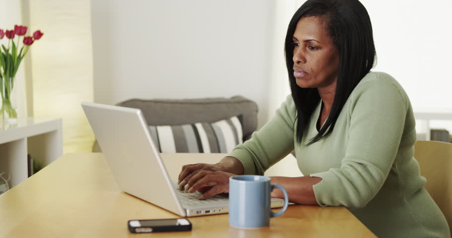 Black Senior Woman Talking Smartphone And Using Computer Stock Footage ...