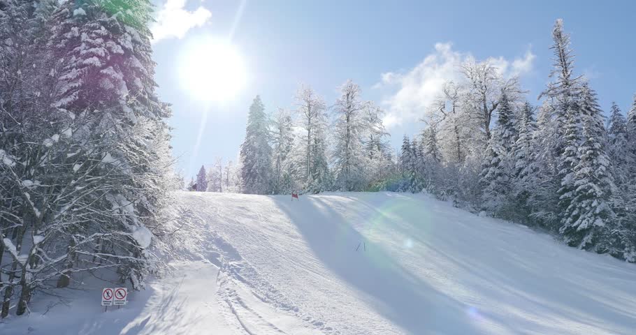 A 4K Shot Of A Beautiful Winter Scene With Some Skiers Skiing Downhill ...